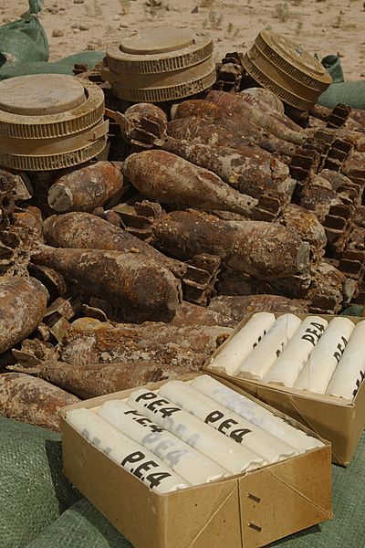 Image: This image shows the pile of UXO and a box of the PE4 explosive ...